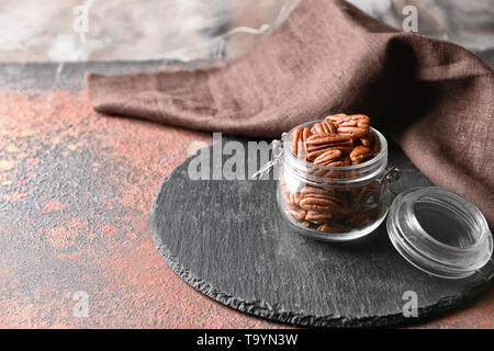 Jar with tasty pecan nuts on table Stock Photo - Alamy