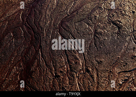 abstract mud background with water washout trails and selective focus ...
