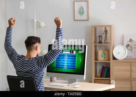 Happy young man after winning computer game in club Stock Photo - Alamy