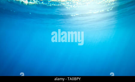 Amazing underwater image of sun and light rays shining through deep ...