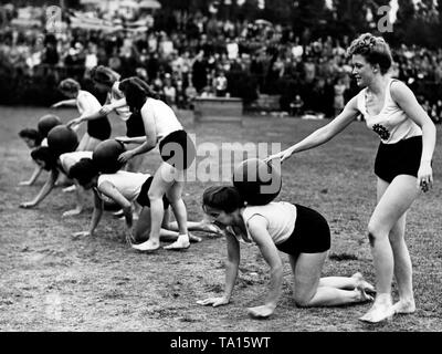 Women do different exercises in a sports competition of the Nazi ...