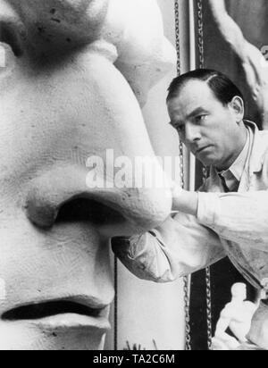 Arno Breker, German sculptor, working on a bust of Gerhart Hauptmann ...