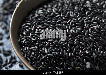 Dry Organic Black Forbidden Rice in a Bowl Stock Photo - Alamy