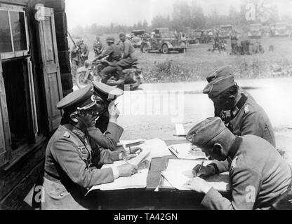 German soldiers at the divisional command post set up the pennant of a ...