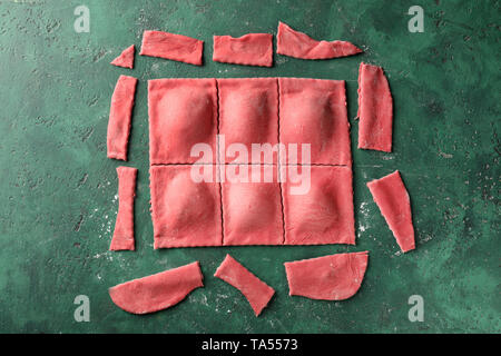 Uncooked ravioli on color background Stock Photo - Alamy