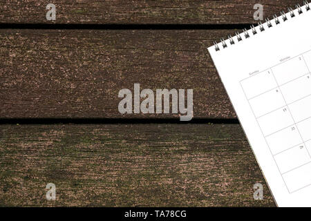 Calendar or planner on dark wood background with copy space. Business ...