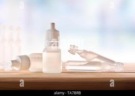 Plastic bottle with eye medication on wooden table Horizontal ...
