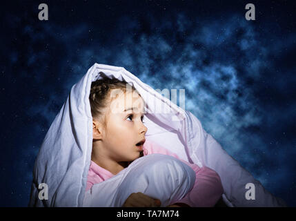 scared child hiding under blanket isolated on black Stock Photo - Alamy