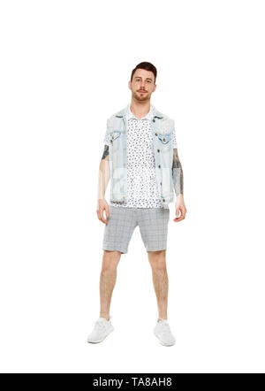 Bearded brunette man with tattoo posing and looking at camera isolated ...