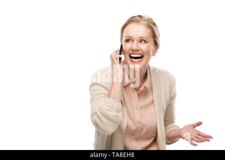 Happy middle-aged woman talking on a landline phone at her workplace ...