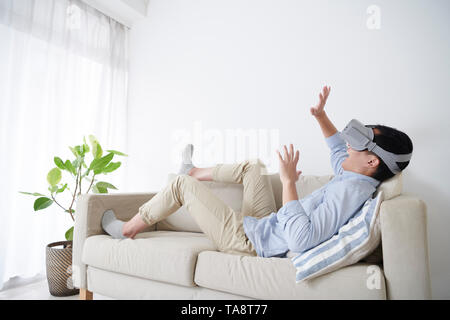 Young Japanese man using VR goggles Stock Photo - Alamy
