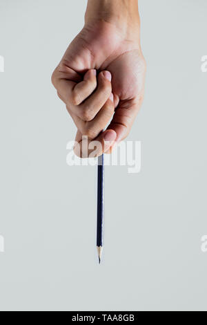 closeup of a young caucasian left-hander man with a sharpen pencil in ...
