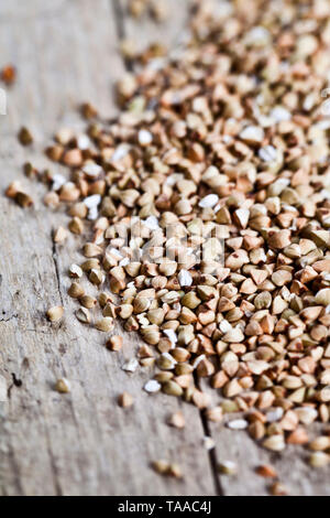 Fresh green dry buckwheat seads closeup on rustic wooden background ...