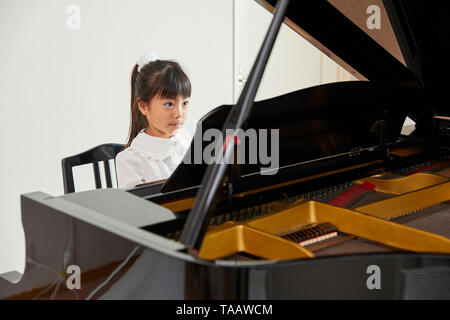 Japanese kid practicing piano Stock Photo - Alamy