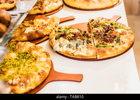 Several small Italian style pizzas in a street stall Stock Photo - Alamy