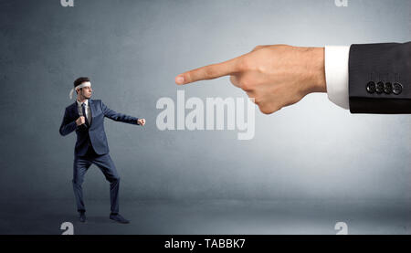 Small karate man fighting with big hand Stock Photo - Alamy