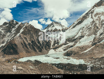 Landscape of rugged Himalayan mountain range against a deep blue sky ...