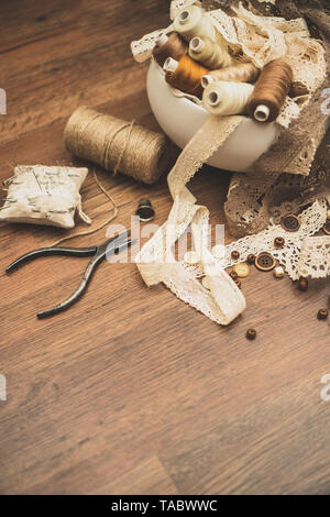 Sewing concept. Thread spools, buttons and sewing needles Stock Photo ...