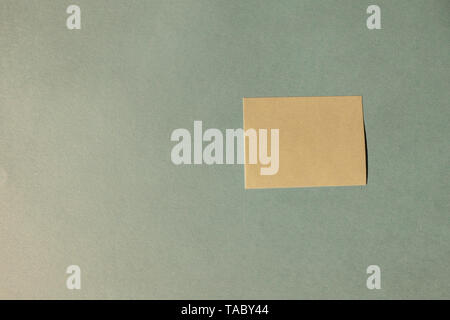 attached yellow note with free text blue background Stock Photo - Alamy