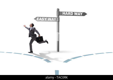 Businessman choosing between hard and easy way Stock Photo - Alamy