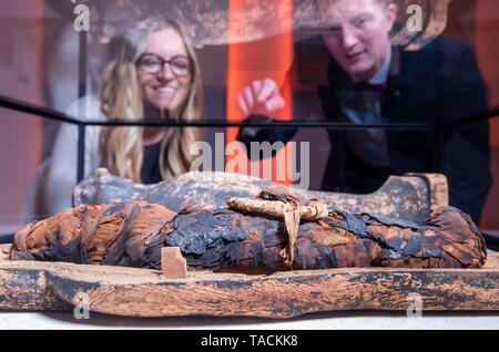 Visitors look at an ancient Egyptian mummy in the British Museum in ...