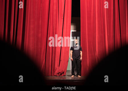 Barefoot actor standing on theatre stage studing the script Stock Photo ...
