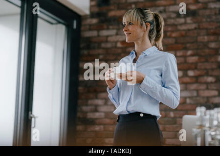 Businesswoman taking coffee break Stock Photo - Alamy