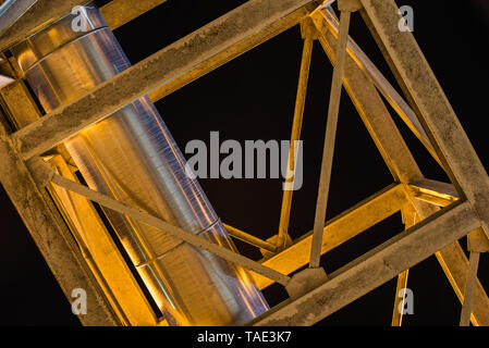 Steel support of boiler pipe in the factory on blue dark night sky ...