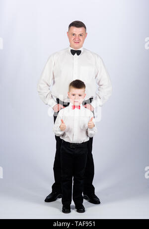 fashion expert. tuxedo style. father and son in formal suit. happy ...