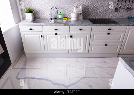 Close-up Of Spilled Water On Kitchen Floor At Home Stock Photo - Alamy