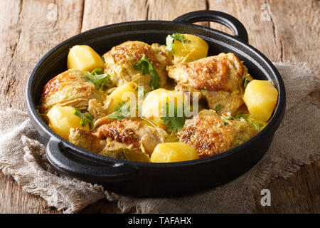 Vibrant red spicy chicken curry with green peppers onions served on ...