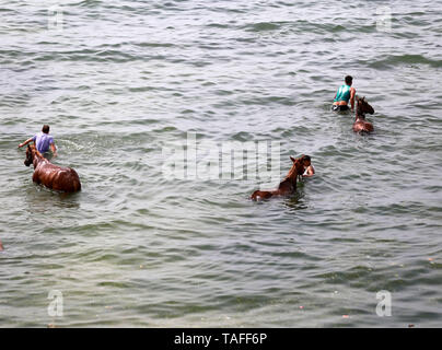 Palestinians enjoy the beach of the Mediterranean Sea during a heat ...