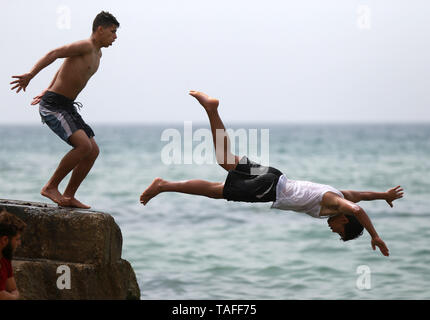 Palestinians enjoy the beach of the Mediterranean Sea during a heat ...