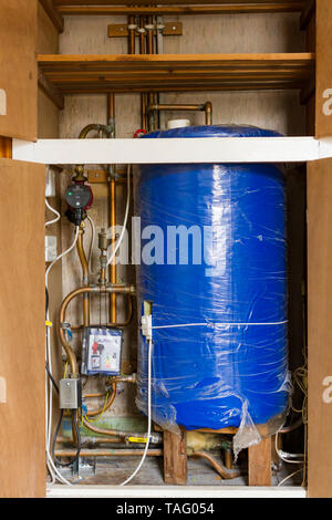 Hot water tank in airing cupboard of a modern British house with a ...