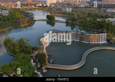 Aerial view of the Kunming Waterfall Park at sunset, one of the largest ...
