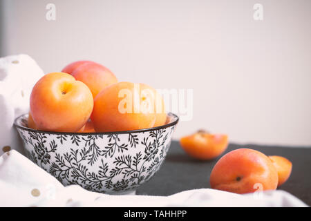 Raw Organic Apricots in a Bowl, side view Stock Photo - Alamy
