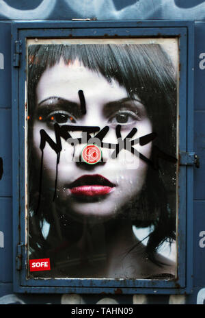 Defaced poster in Soho, London, England Stock Photo - Alamy