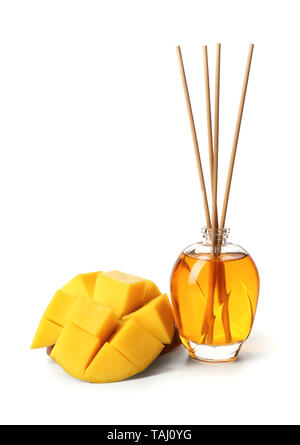 Reed diffuser and mango on white background Stock Photo - Alamy