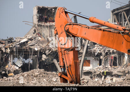 Big demolition machine demolishing a factory Stock Photo - Alamy