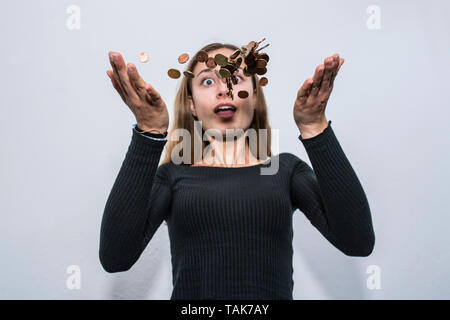 Teenage girl throwing money coins in the air Stock Photo - Alamy