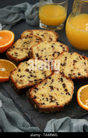 Tasty cupcake with fruits on slate plate over light wooden background ...
