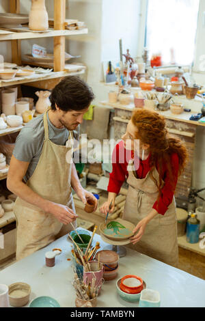 Business woman in red shirt with notepad in hands of work professionals ...