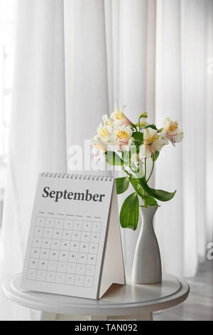 Flip calendar with page of September on color background Stock Photo ...