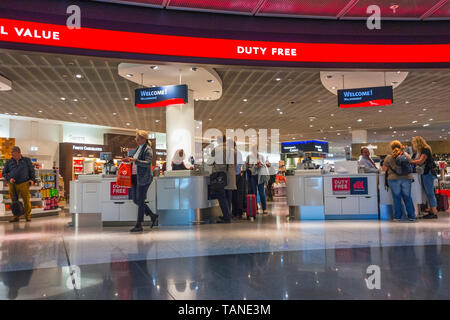 woman traveller shopping for duty free free alcohol in an airport duty ...