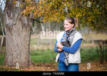 Close-up of woman holding rabbit Stock Photo - Alamy