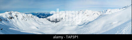 Panoramic view across snow covered alpine mountain ski slope piste in ...