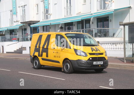 AA breakdown van driving along town centre high street deals with Auto ...