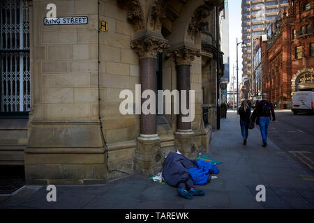 Contrasting homeless man sleeping rough Manchester city centre King ...