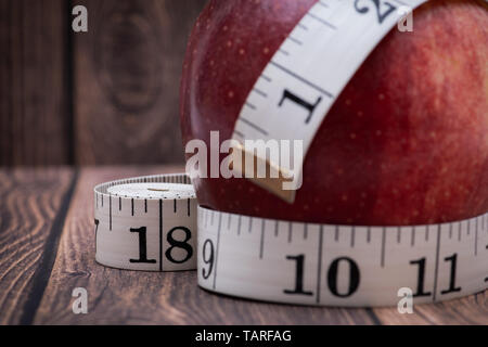 Red Apple and Soft Vinyl Measuring Tape on wooden background Stock ...