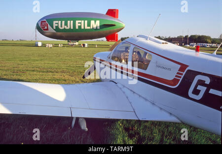Fuji airship blimp at aerodrome airfield 1980s ground crew vans during ...